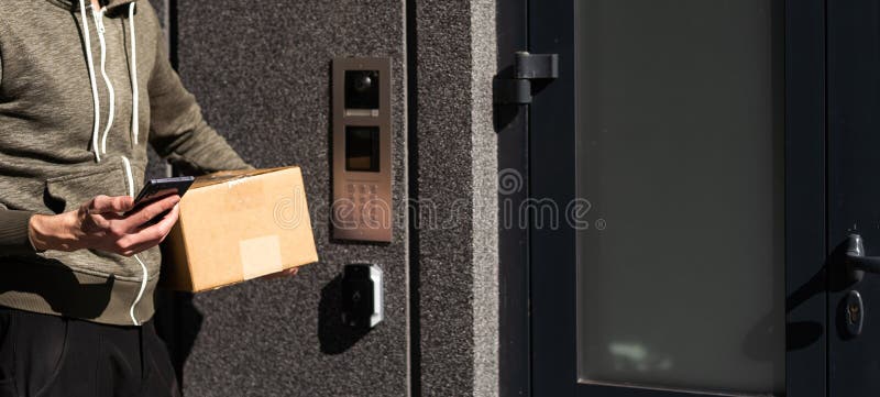 Happy Man Ringing Intercom with Camera in Entryway. Stock Photo - Image ...