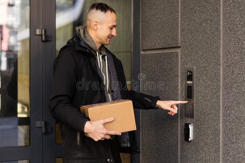 Happy Man Ringing Intercom with Camera in Entryway. Stock Image - Image ...