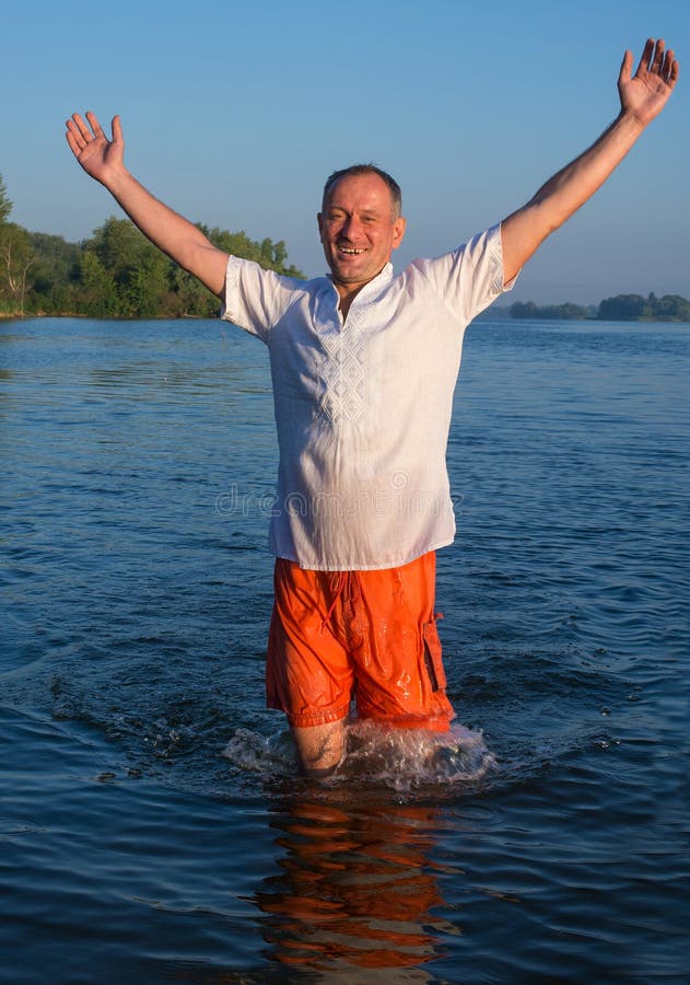 Happy man running in water stock photo. Image of cheers - 55646826