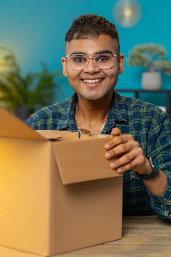 Happy Man Shopper Unpacking Cardboard Box Delivery Parcel Online Shopping Purchase At Home