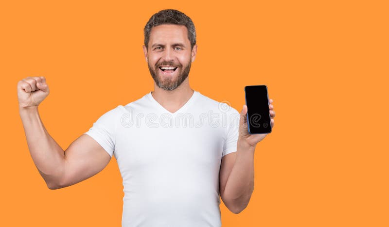 Happy Man Showing Phone Screen in Studio. Man Showing Screen of Phone ...