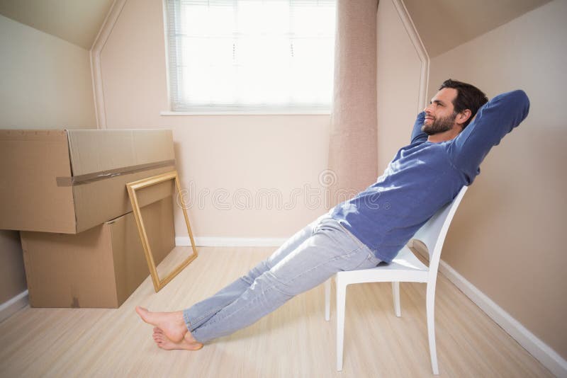 Happy Man Sitting Back after Moving in Stock Photo - Image of home ...