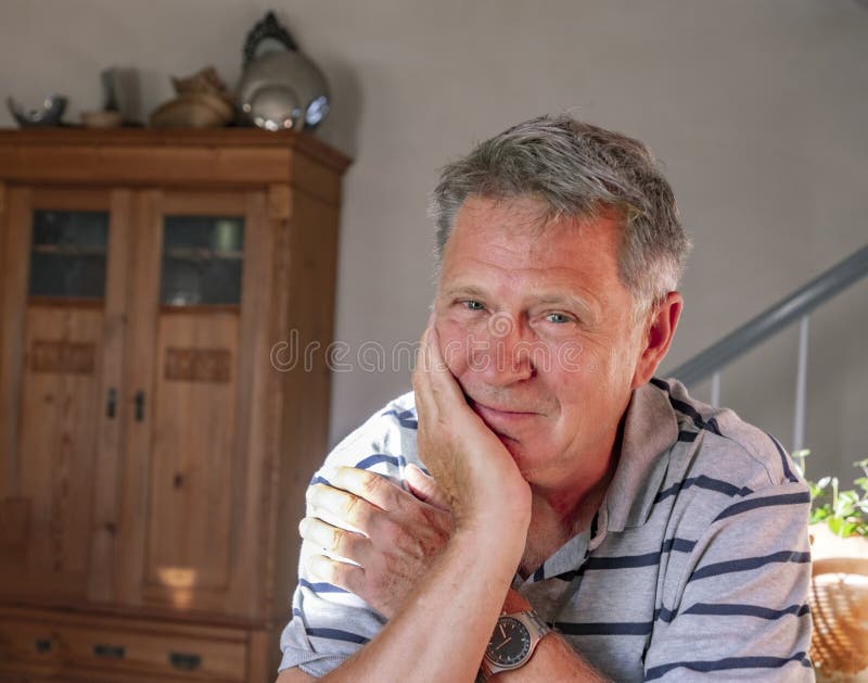 Happy Man Sitting at Home at the Table and Smiles Stock Image - Image ...
