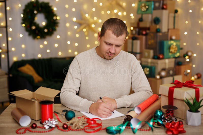 Man Sitting by the Table and Writing Something on Paper Stock Image ...