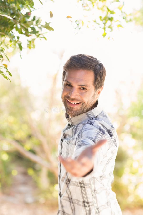 Happy Man Smiling at Camera Offering Hand Stock Image - Image of ...