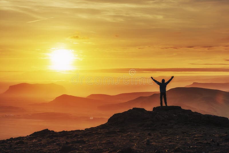 Happy Man Standing on a Cliff at Sunset Stock Photo - Image of backlit ...