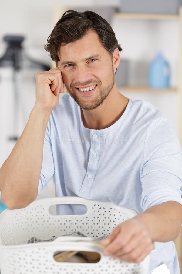 Happy Man Taking Clothes from Drying Rack Stock Image - Image of ...