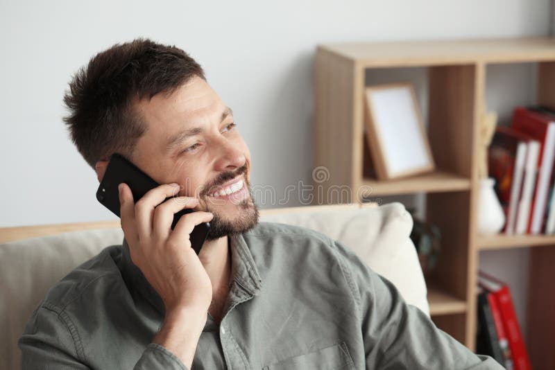 Happy Man Talking on Smartphone at Home Stock Image - Image of ...