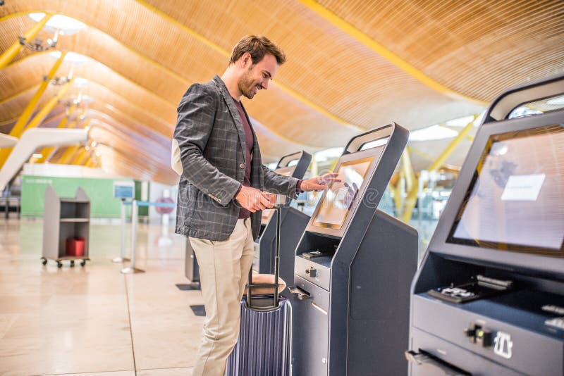 Happy Man Using the Check-in Machine at the Airport Getting the Stock ...
