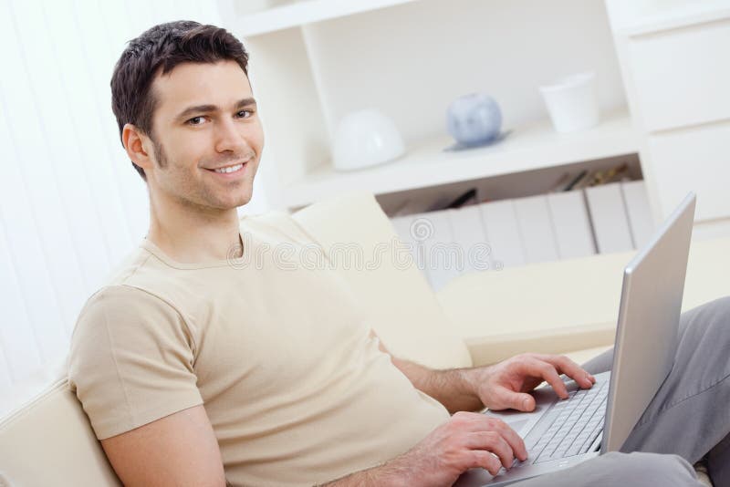 Happy man using computer stock photo. Image of comfort - 11413296
