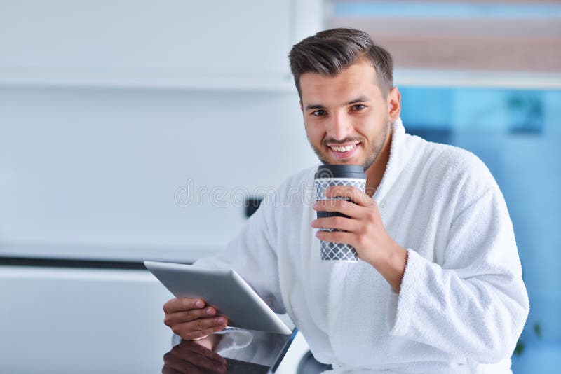 Happy Man Using Digital Tablet while Having Coffee in Kitchen Stock ...