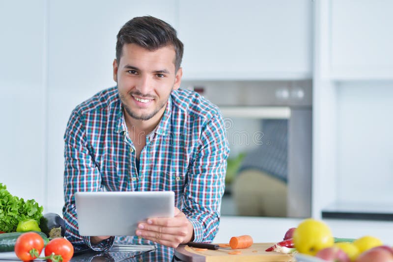 Happy Man Using Digital Tablet in Kitchen at Home Stock Photo - Image ...