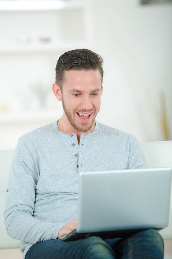 Happy man using laptop stock image. Image of browsing - 239076097