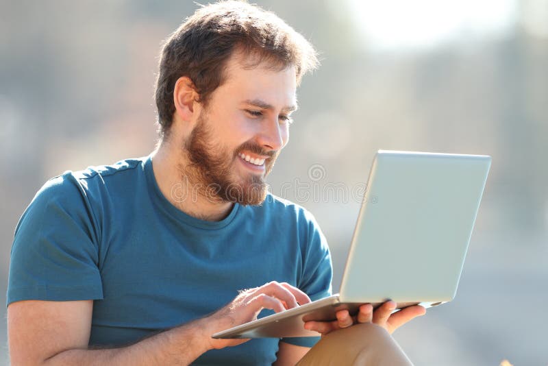 Happy Man Using Laptop Sitting in Nature Stock Photo - Image of ...