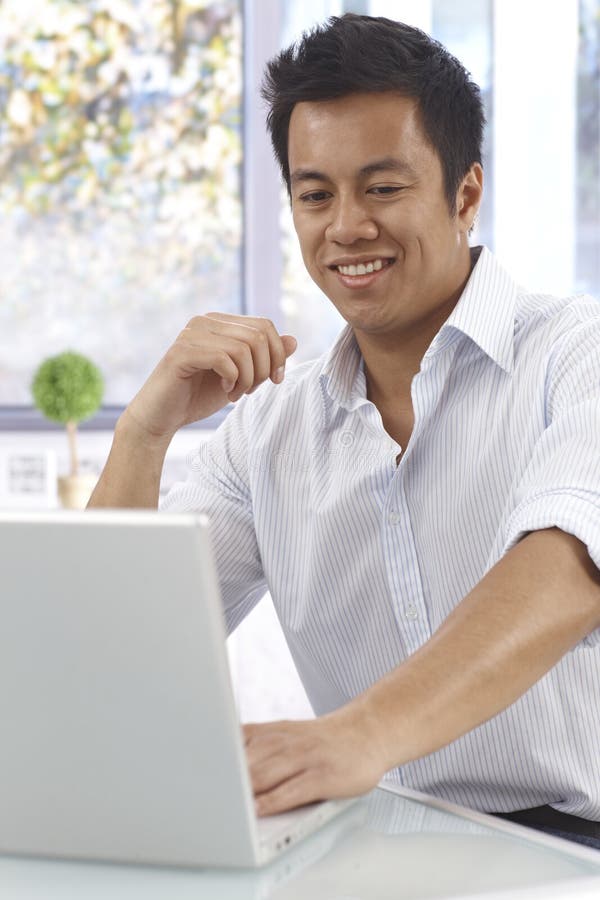 Happy man using laptop stock photo. Image of leisure - 71129674