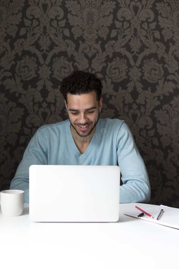 Happy man using a laptop stock image. Image of online - 67693269