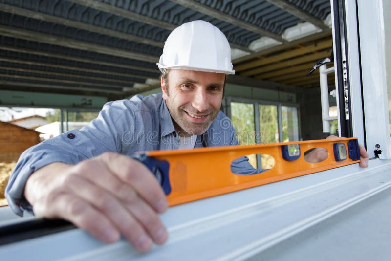 Happy man using level stock image. Image of bricolage - 174010257