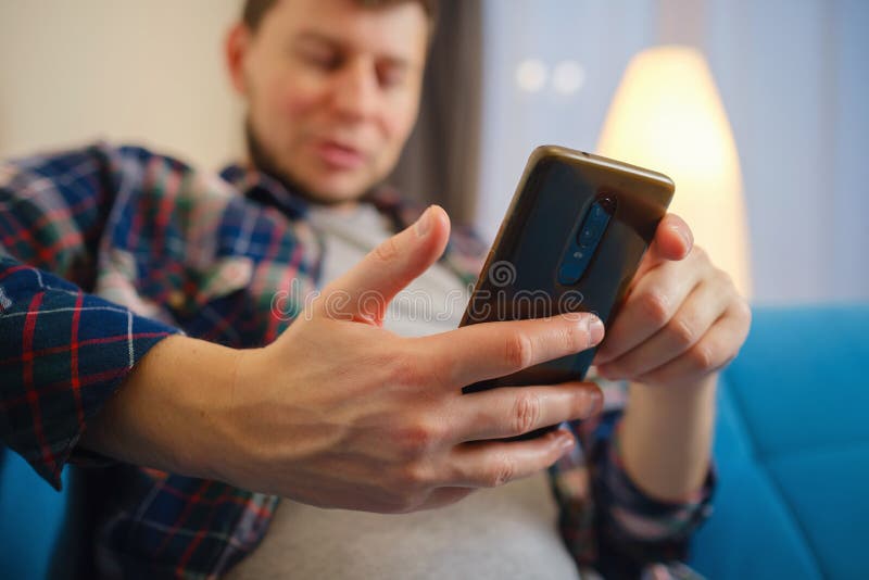 Happy Man Using Mobile Phone at Home Stock Photo - Image of smartphone ...