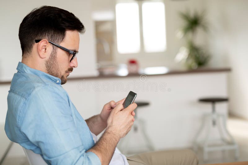 Happy Man Using Mobile Phone at Home Stock Image - Image of office ...