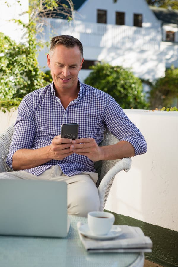 Happy Man Using Mobile Phone while Sitting in Cafe Stock Photo - Image ...