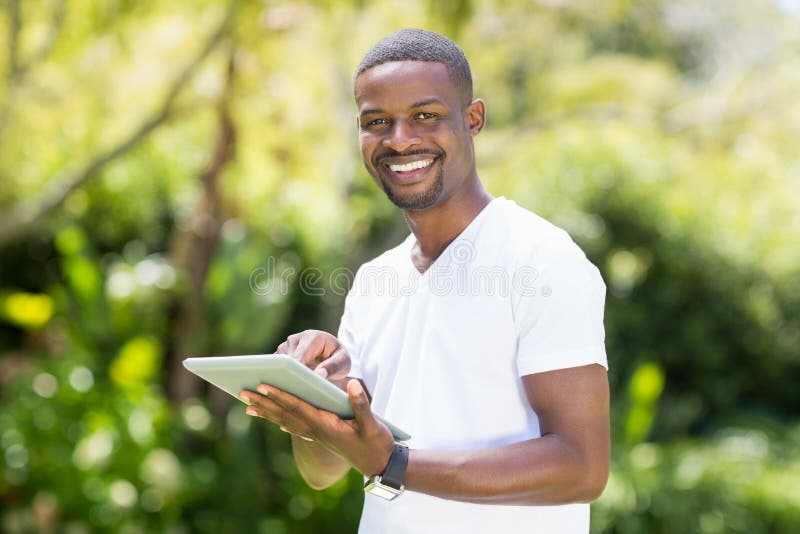 Happy man using a tablet stock image. Image of adult - 69806151