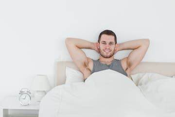 Happy man waking up stock image. Image of laying, alarm - 22143235
