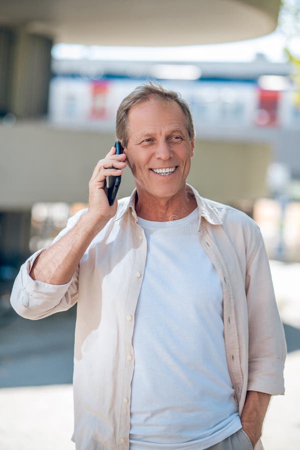 Happy Man Walking on Street and Talking by His Phone. Stock Image ...