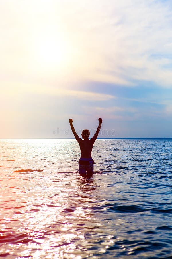 Happy Man in the Water stock image. Image of arms, clouds - 128247707
