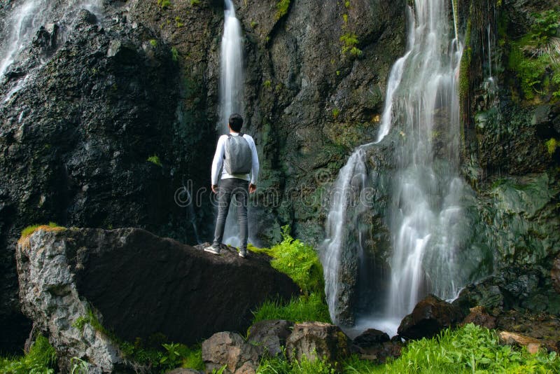 Happy man and waterfall stock image. Image of outdoor - 253778369