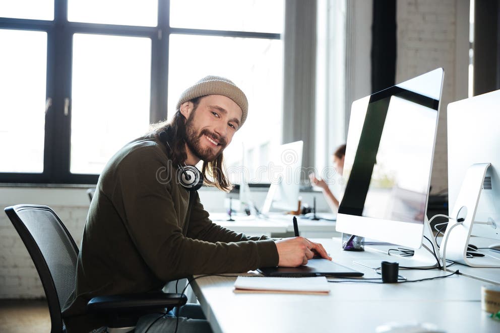 Happy Man Work in Office Using Computer. Looking at Camera Stock Photo ...