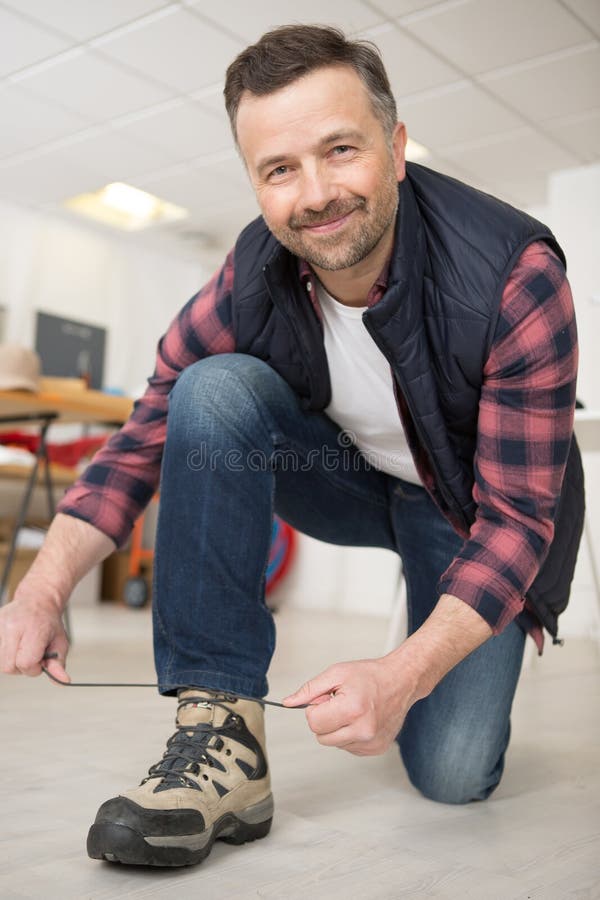 Happy Man Worker Doing Up Laces Stock Photo - Image of closeup, foot ...