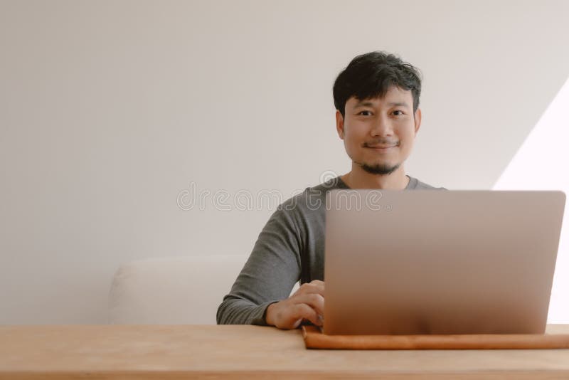 Happy Man Working with Computer Over Empty Space White Wall. Stock ...