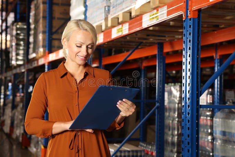 Happy Manager Holding Clipboard in Warehouse with Lots of Products ...