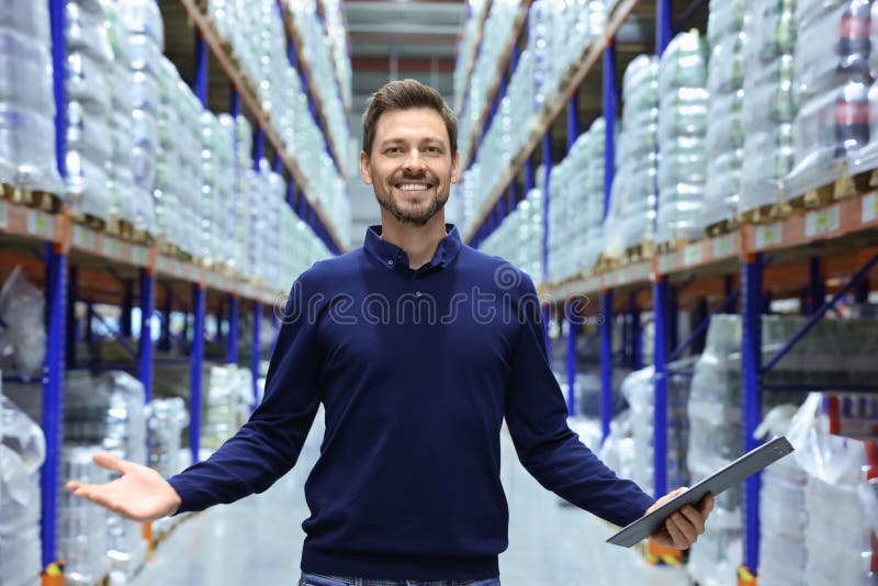 Happy Manager Holding Clipboard in Warehouse with Lots of Products ...