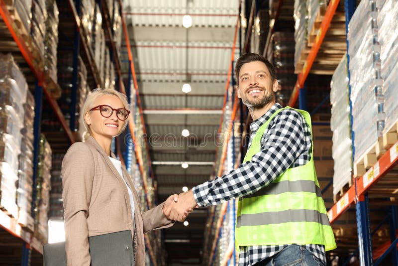 Happy Manager Shaking Hands with Worker in Warehouse Stock Photo ...