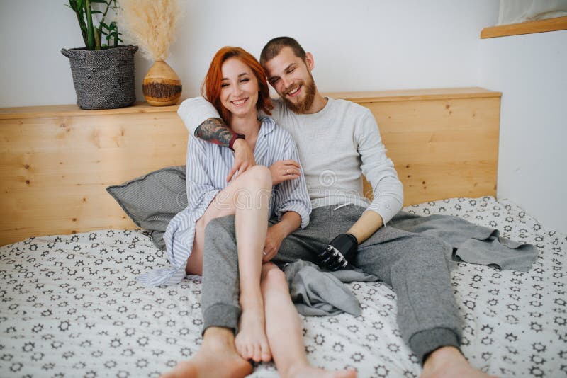 Happy Married Couple Chilling On A Double Bed At Home Stock Image