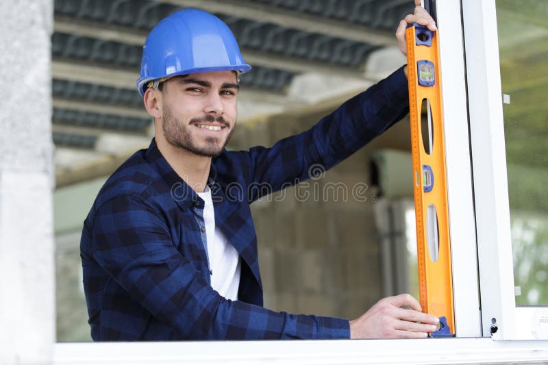 Happy Master Checks Level before Installation Window Stock Photo ...
