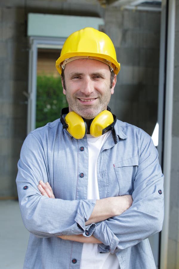 Happy Mature Builder Outdoors in Hardthat Looking at Camera Stock Photo ...