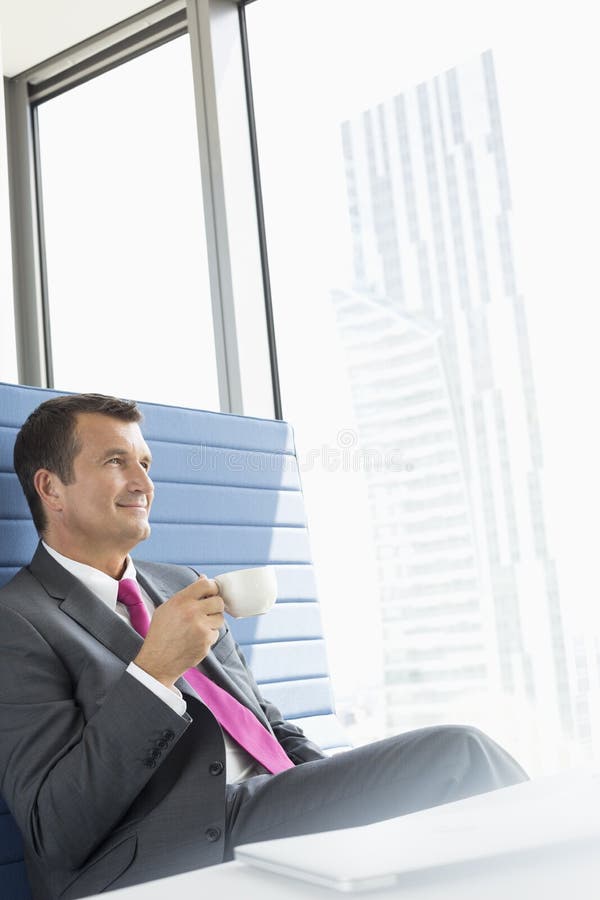 Happy Mature Businessman Taking Coffee Break in Office Stock Photo ...