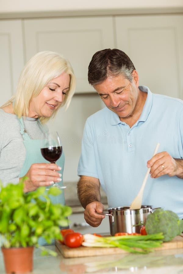 Happy Mature Couple Making Dinner Together Stock Image - Image of ...