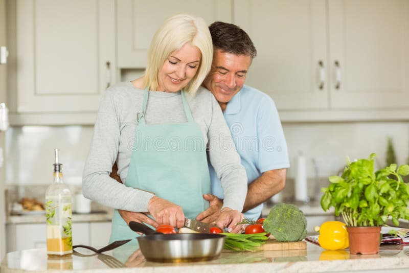Happy Mature Couple Making Dinner Together Stock Image - Image of knife ...
