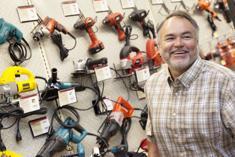 Happy Mature Hardware Store Owner Looking Away Stock Photo - Image of ...