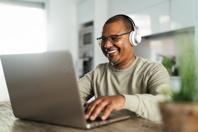 Happy Mature Latin Man Using Laptop at Home Stock Photo - Image of ...
