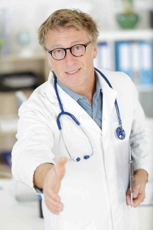 Happy Mature Man Doctor Smiling while Giving Handshake Stock Image ...