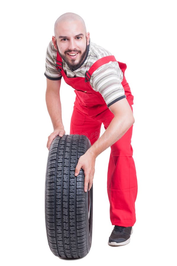 Happy Mechanic Pushing And Rolling A Car Wheel Stock Photo - Image of ...