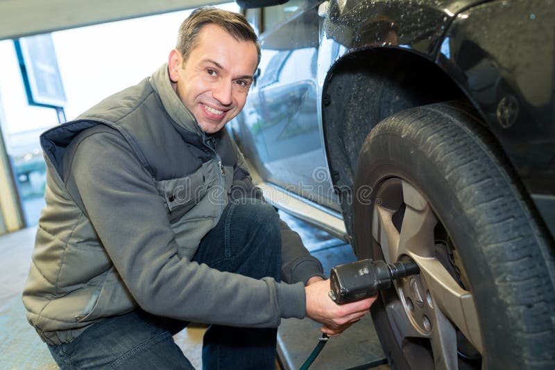 Happy Mechanic in Tyre Store Warehouse Stock Image - Image of tyres ...