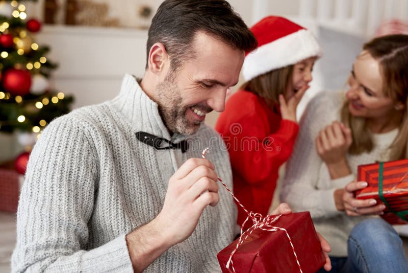 Happy Man Opening Christmas Present Stock Image - Image of christmas ...