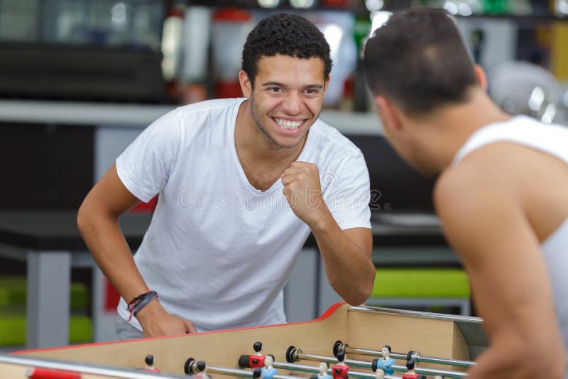 Happy Men Playing Football Table Stock Photo - Image of friends ...