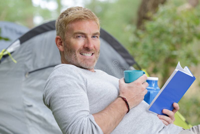 Happy Middle Age Man Reading Book Outdoors Stock Image - Image of young ...