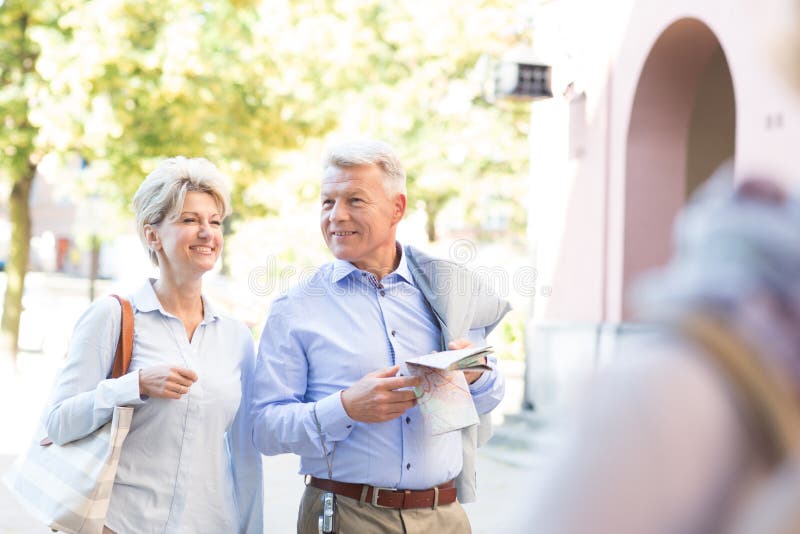 Happy Middle-aged Couple with Map Walking in City Stock Photo - Image ...